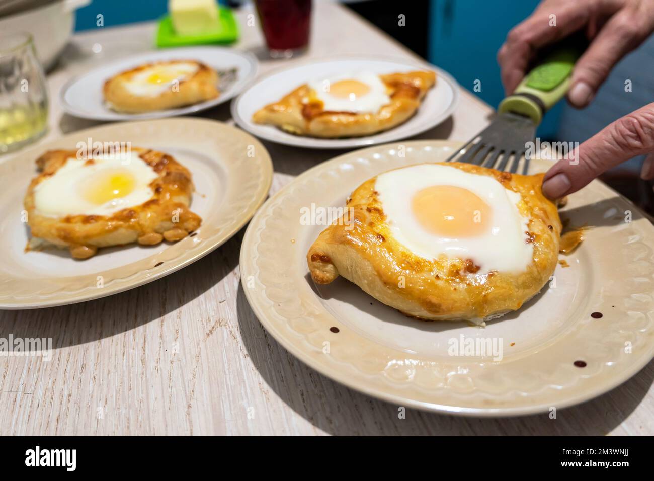 Traditional Georgian bread - khachapuri madjarski with cooker hand ...