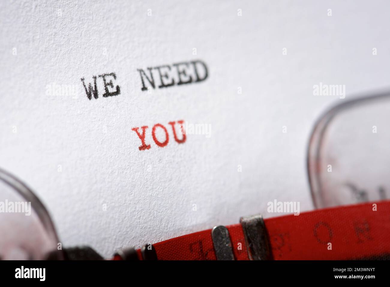 We need you phrase written with a typewriter Stock Photo - Alamy