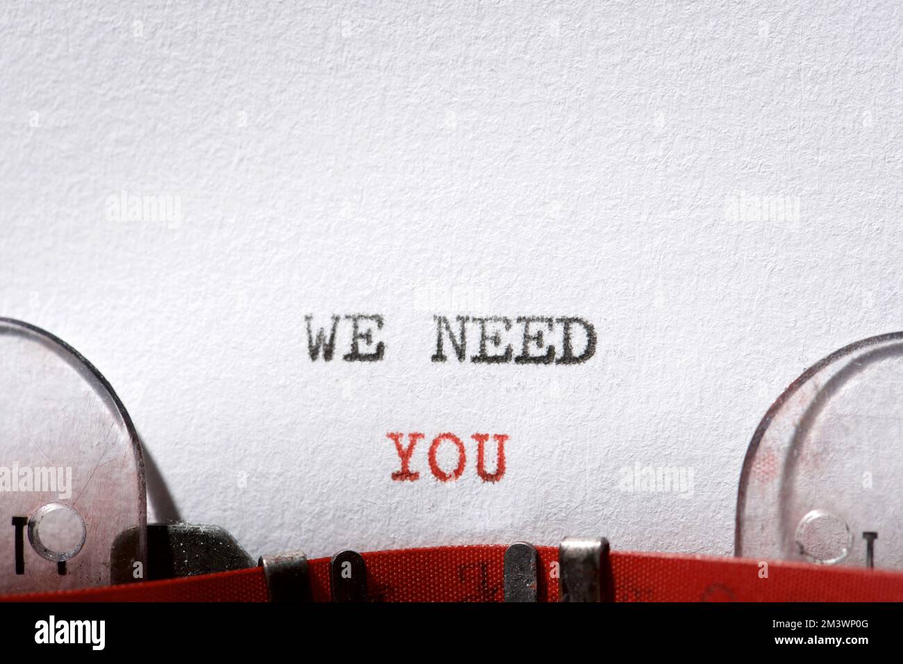 We need you phrase written with a typewriter Stock Photo - Alamy