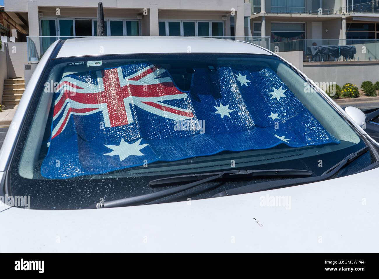 17 December 2022: Sun shade with Australian flag in car windscreen ...