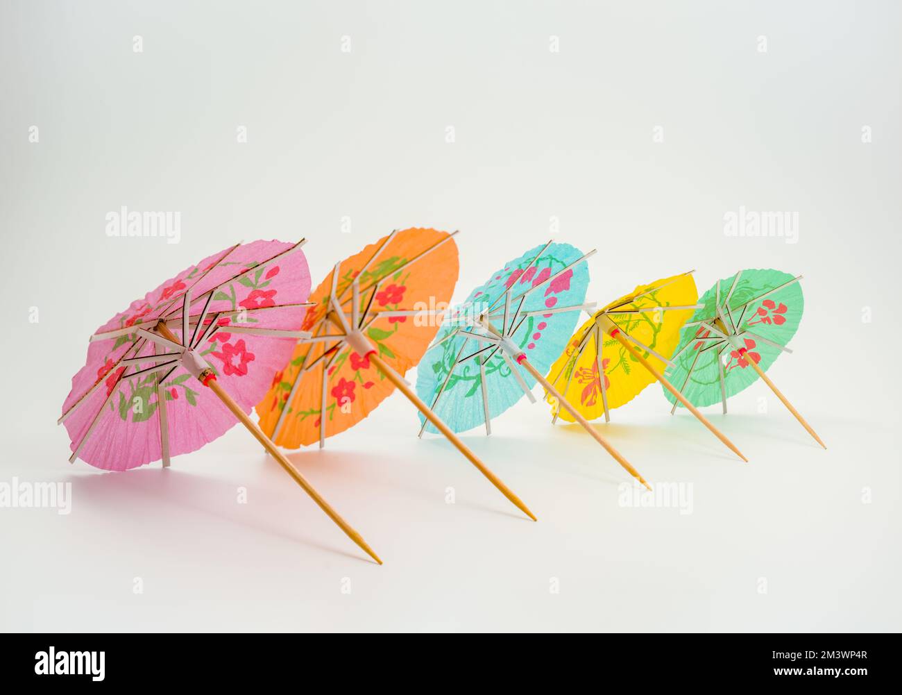 perspective view of a row of cocktail parasol umbrellas isolated ...