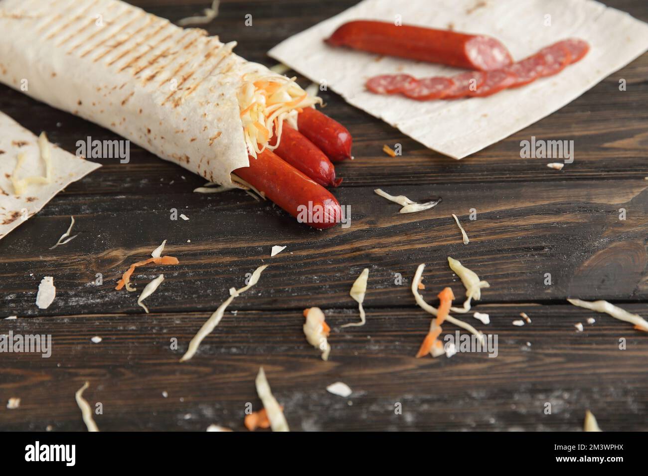 smoked sausage in pita bread on a wooden table Stock Photo - Alamy