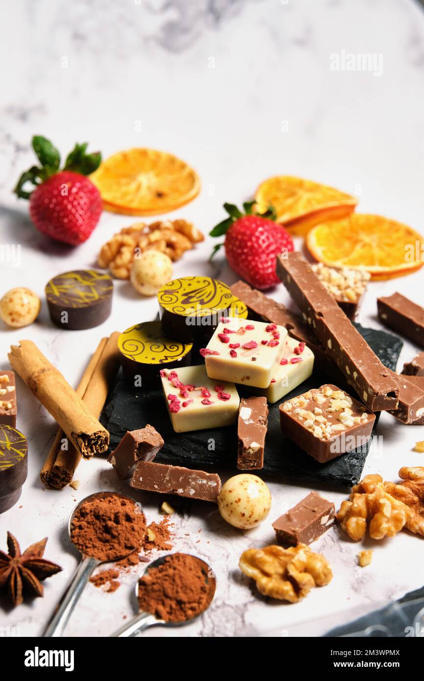 a variety of chocolates on a light background Stock Photo - Alamy