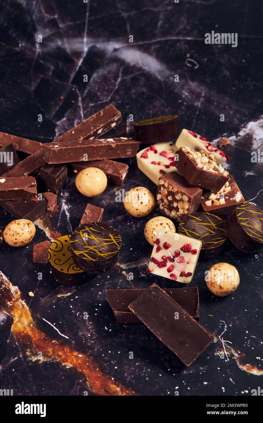 a variety of chocolates on a dark background Stock Photo - Alamy