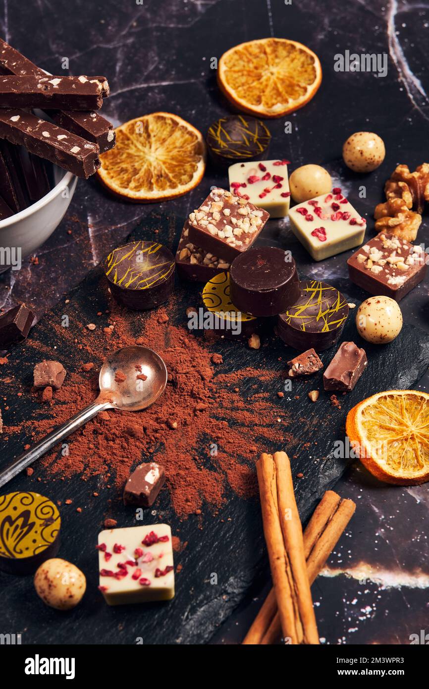 a variety of chocolates on a dark background Stock Photo - Alamy