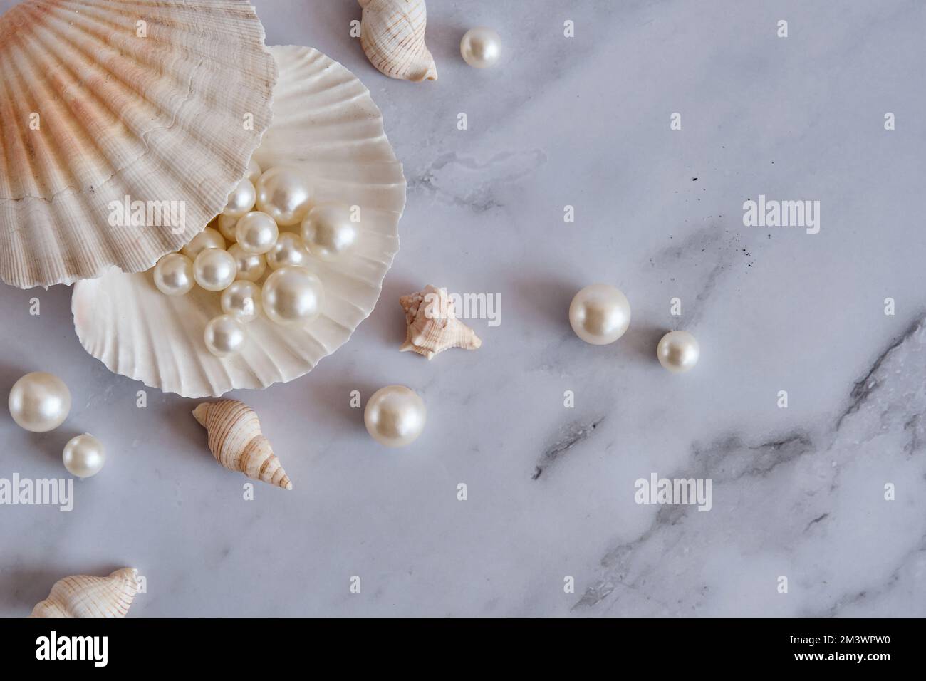 pearls in a shell on a marble background Stock Photo - Alamy