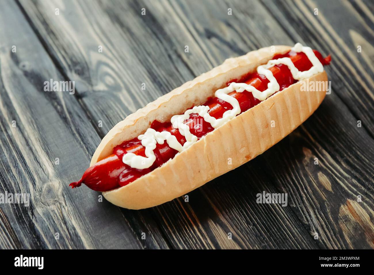 hot dog with smoked sausage and mayonnaise on wooden background Stock ...