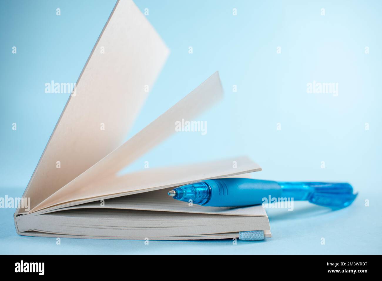 An open notebook and a blue paper in the studio Stock Photo - Alamy