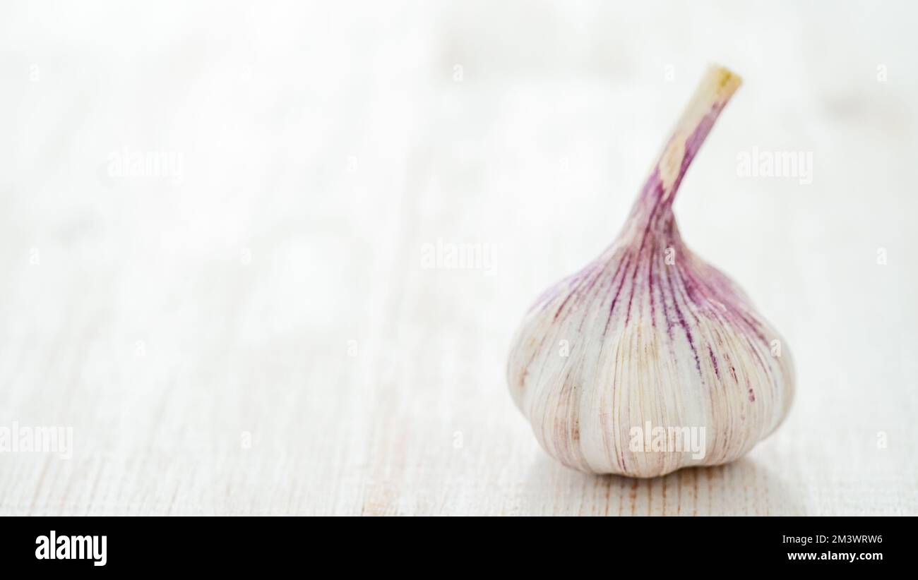 Garlic bulb on white wooden background. Perfect head of garlic with ...