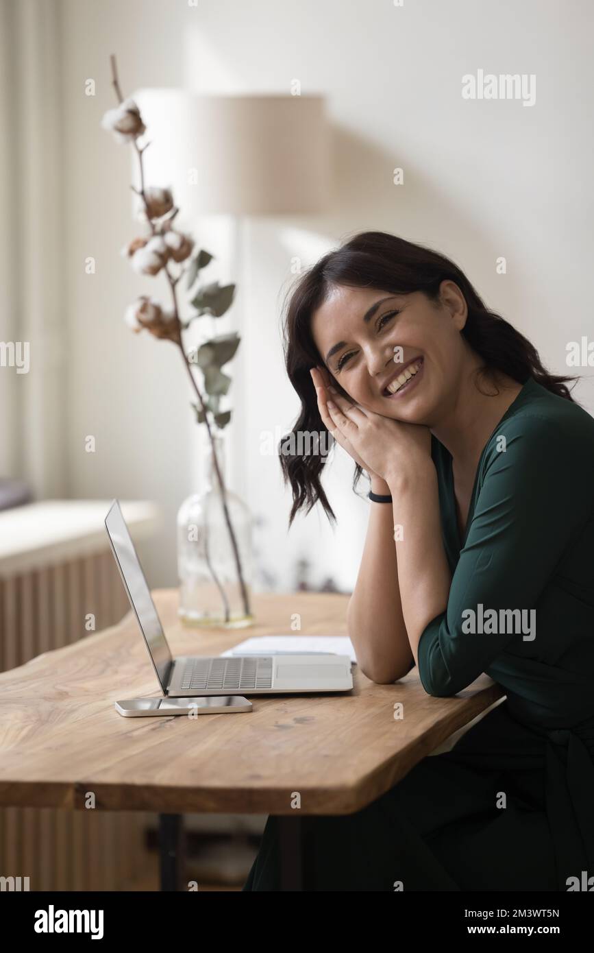 Cheerful pretty freelance employee sitting at home office workplace ...