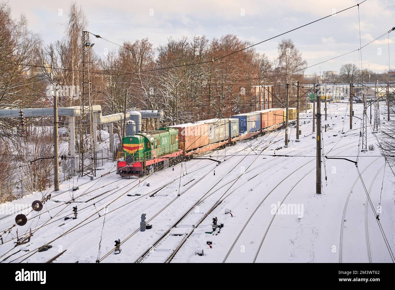 Riga, Latvia - 8 December, 2022: Short freight train on snowy railroad ...