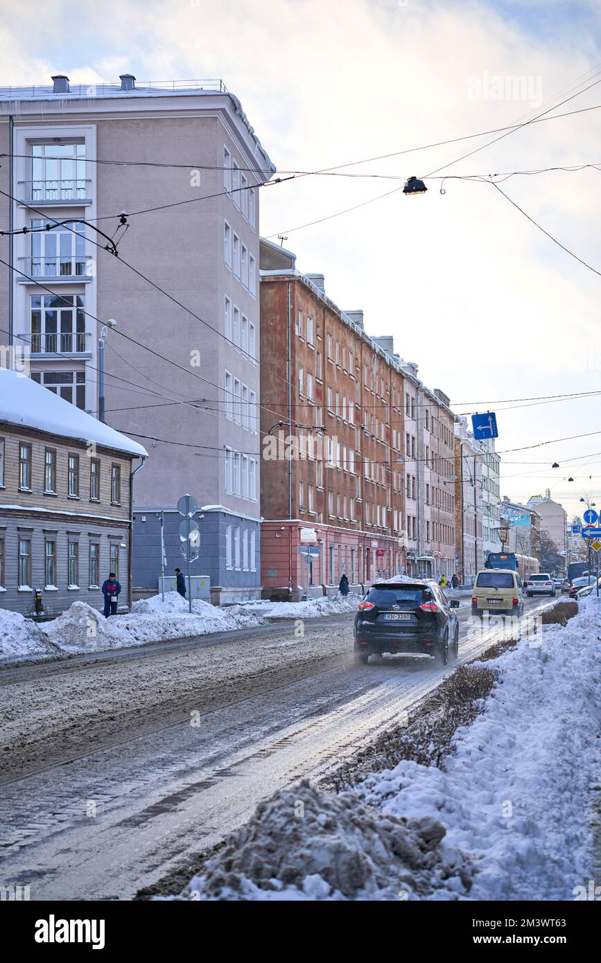 Riga, Latvia - December 8, 2022: Modern tram and cars on the snowy ...