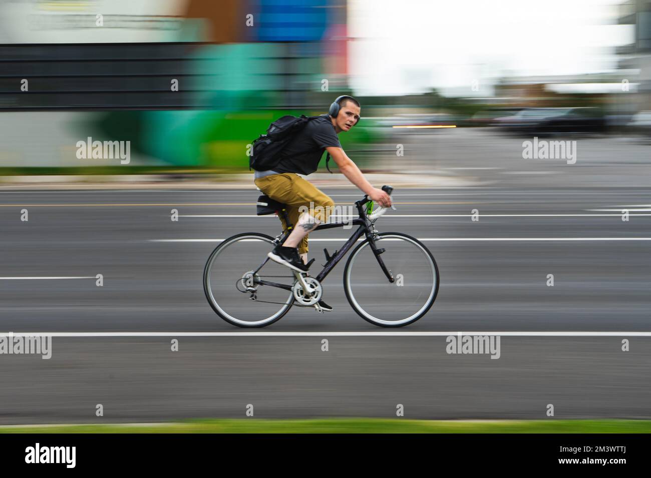 A beautiful shot of a guy riding his bike with a blurred background ...