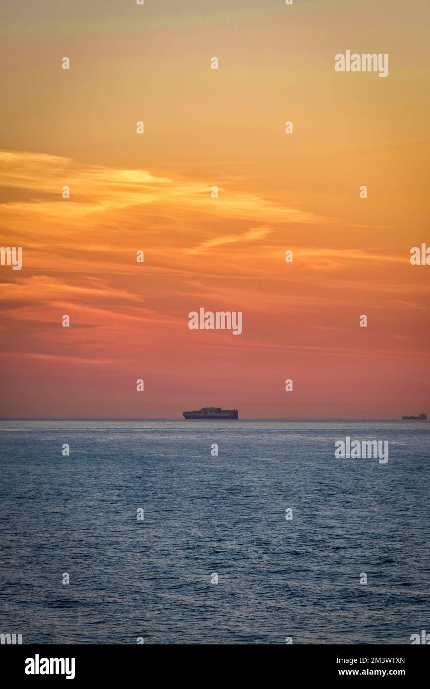 A vertical shot of a beautiful seascape and ships on water at scenic ...