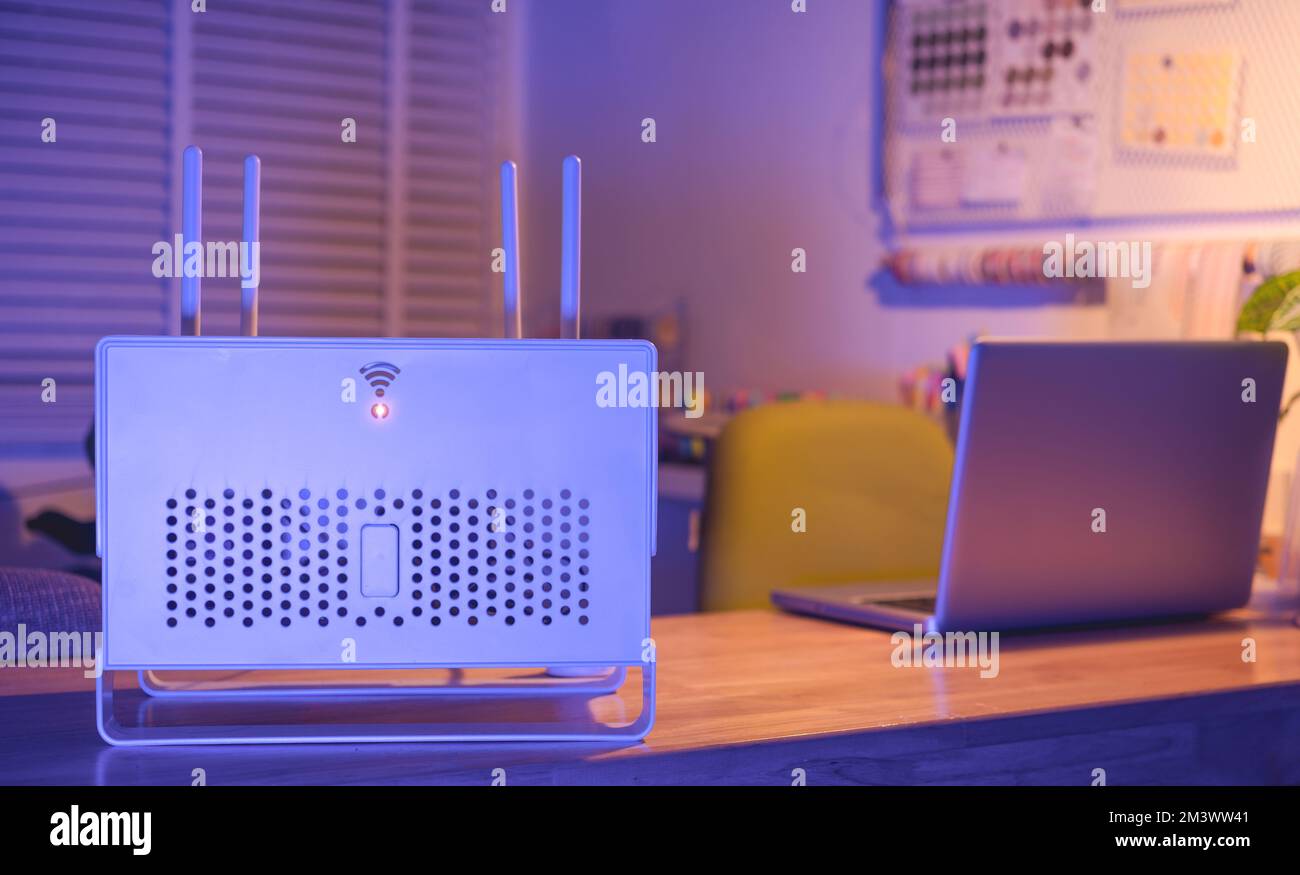 closeup of a wireless router and Laptop computers on living room at ...