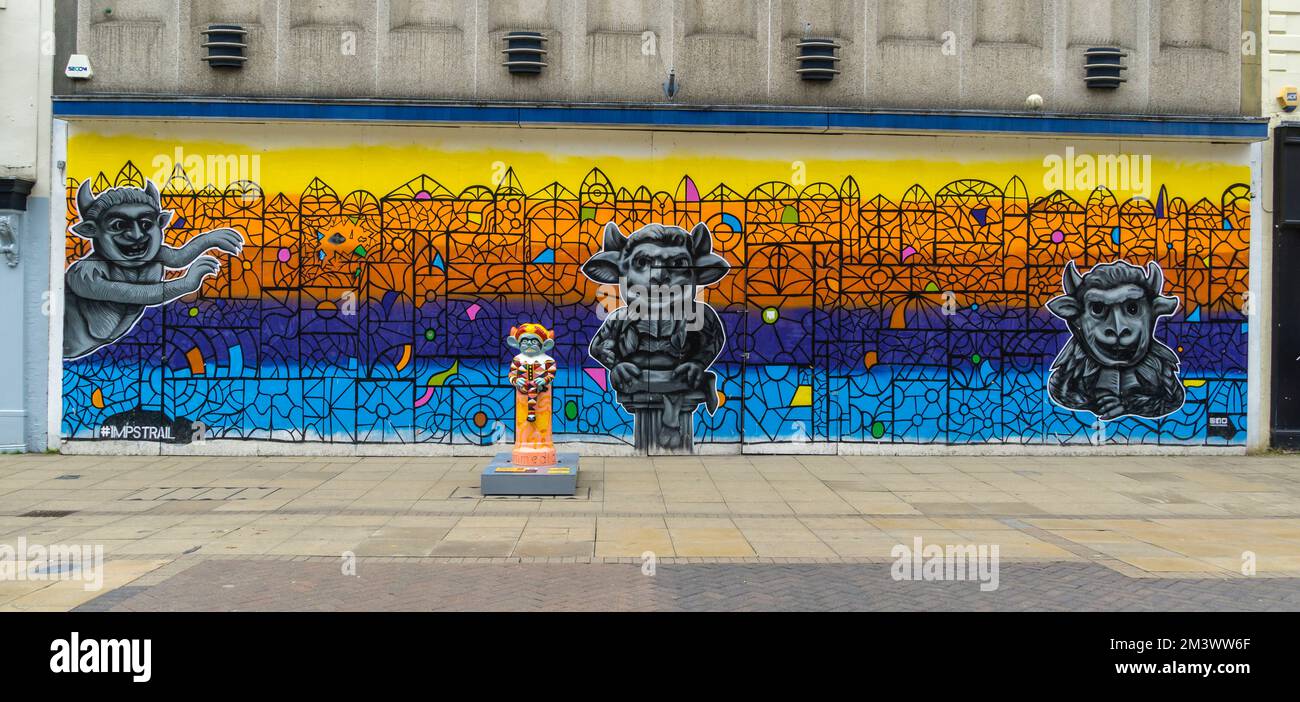 Harlequin imp in front of impstrail mural high street lincoln city 2021 ...