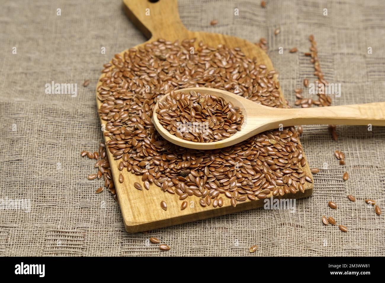 Brown flax seed background. Flaxseed oil preparation. Flax oil is rich in omega-3 fatty acid ...