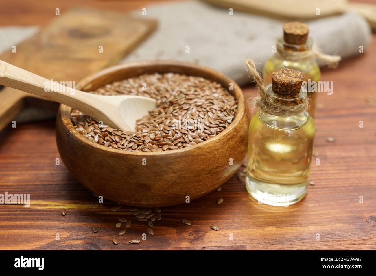 Brown flax seeds on spoon and flaxseed oil. Flax oil is rich in omega-3 ...