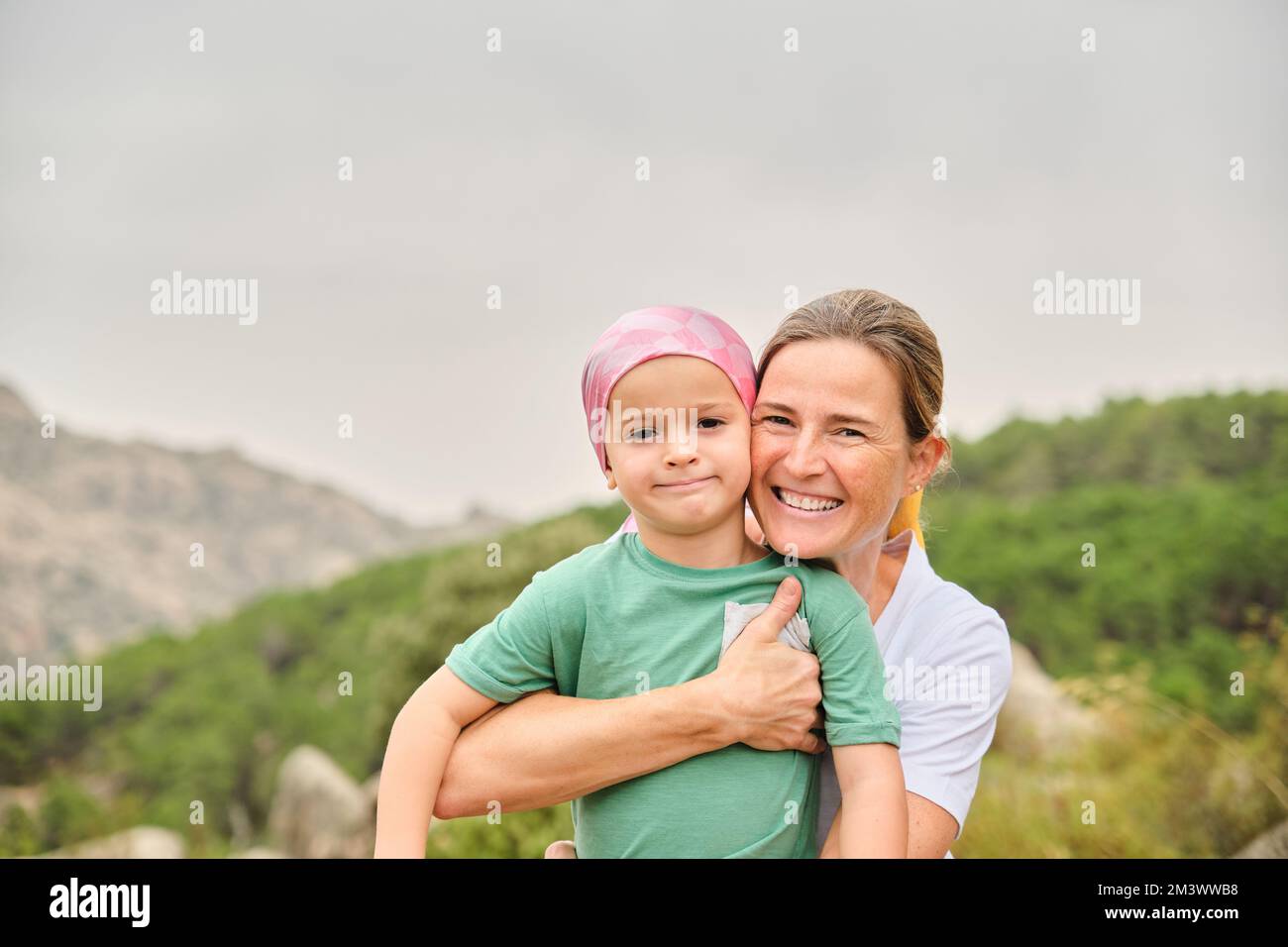 Mother hugging her son with cancer in nature Stock Photo - Alamy