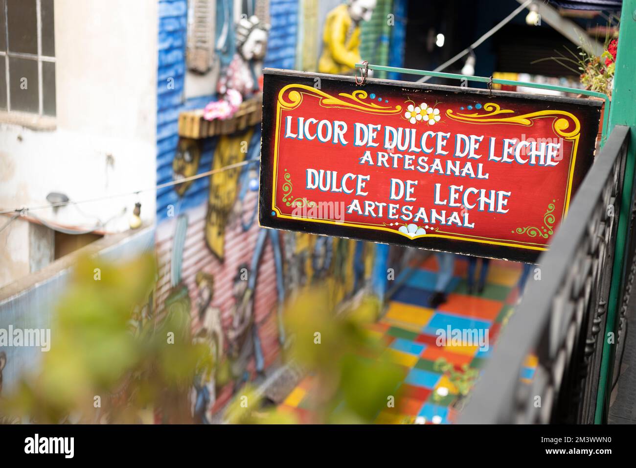 A closeup of a red board with Argentinian typical painted writing ...