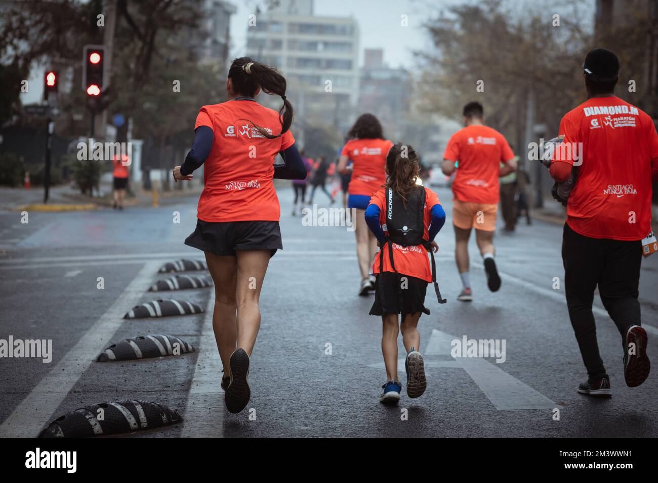 A rear of people during Gatorade running wearing orange suits in ...