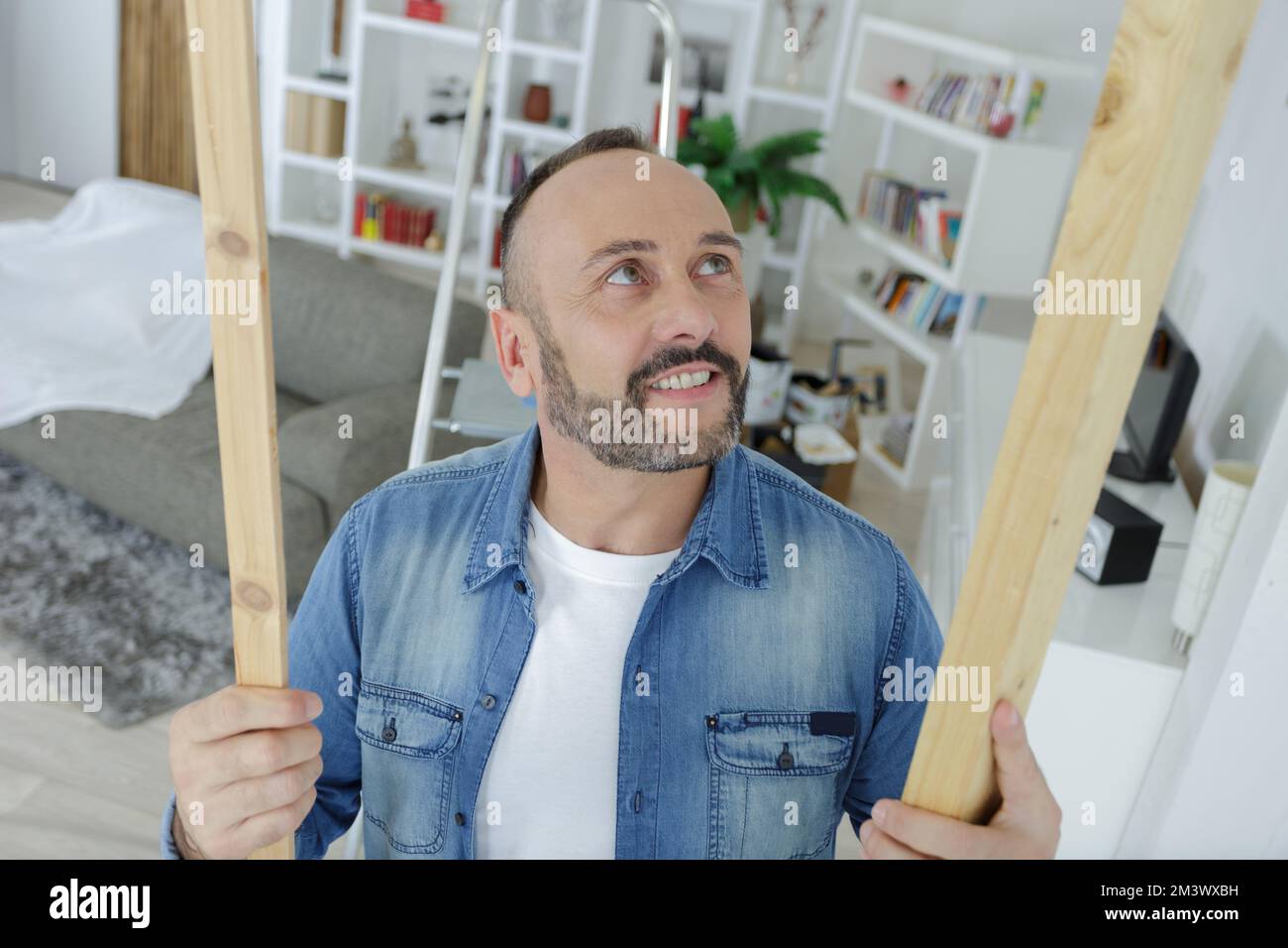 man checking wood at home Stock Photo - Alamy