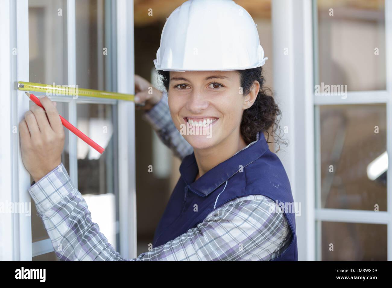 a woman measuring window frame Stock Photo - Alamy