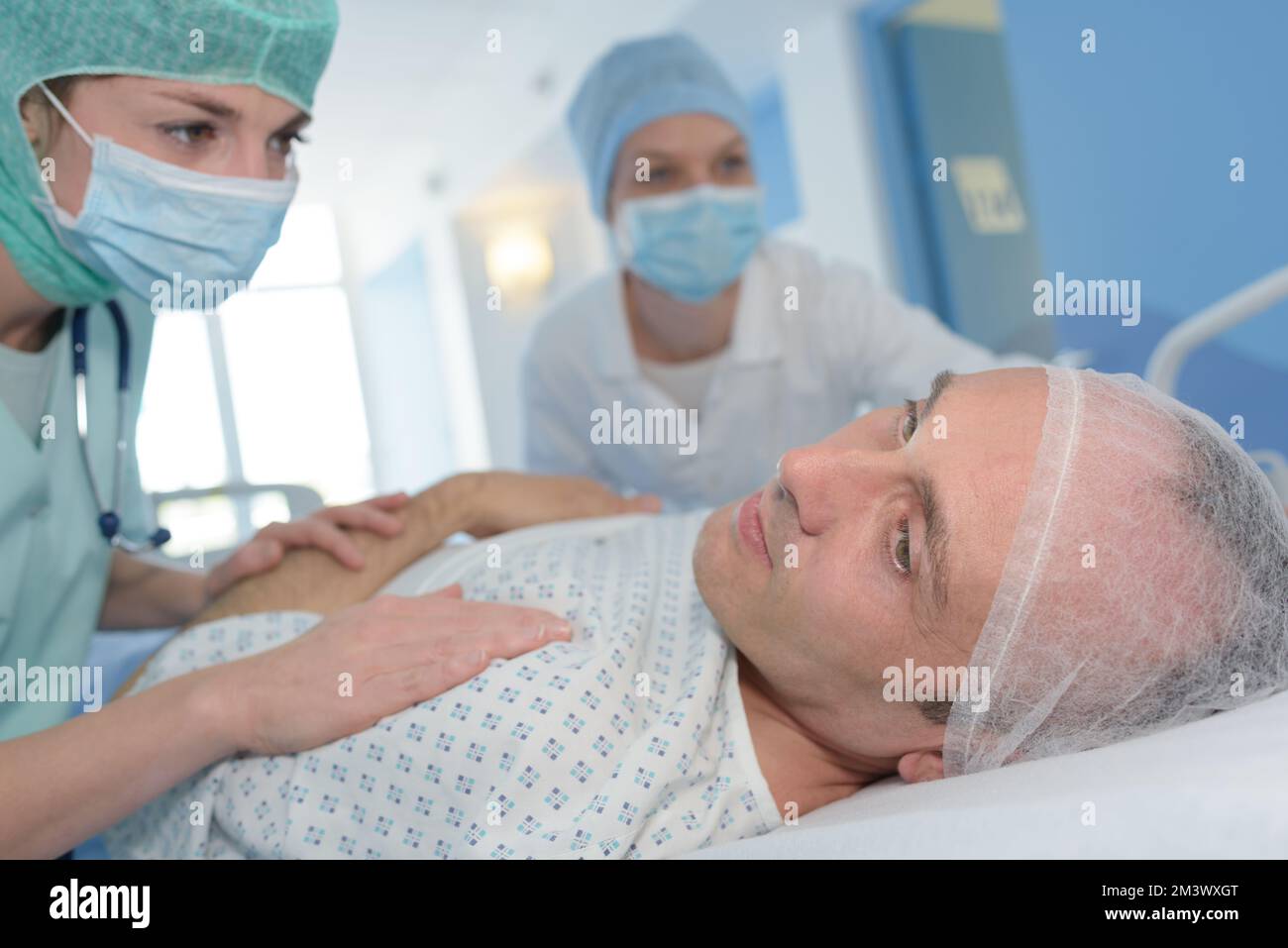nurse and surgeon assisting patient on bed Stock Photo - Alamy