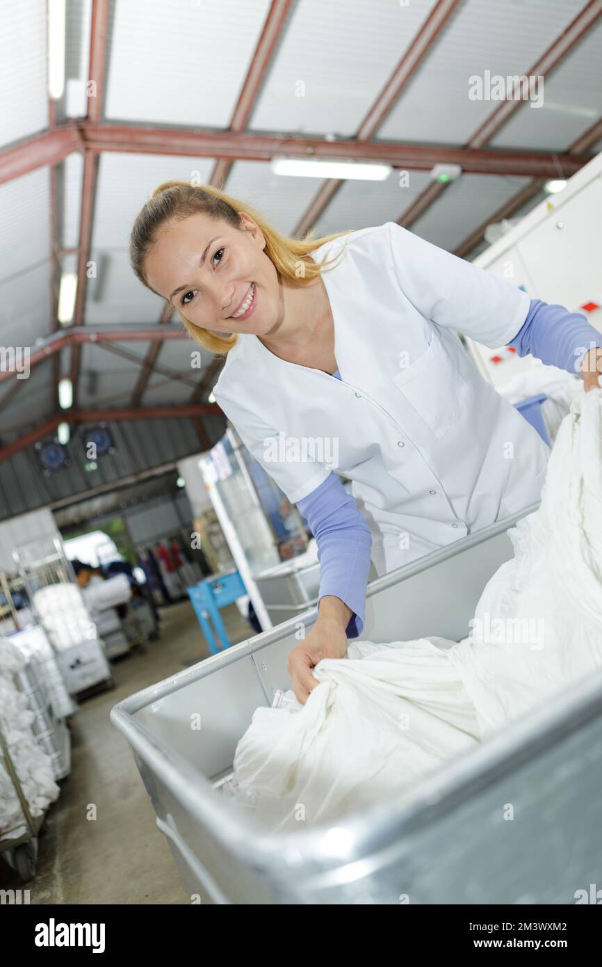 Female laundry worker ironing hi-res stock photography and images - Alamy