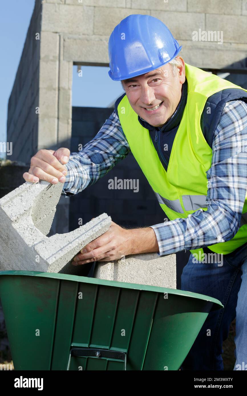 Construction worker carrying bricks hi-res stock photography and images ...