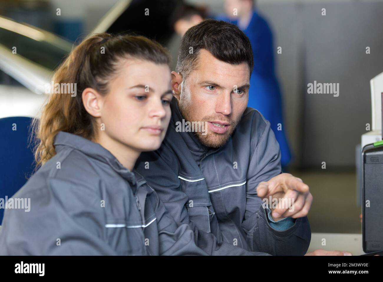 mechanic and apprentice working on computer Stock Photo - Alamy