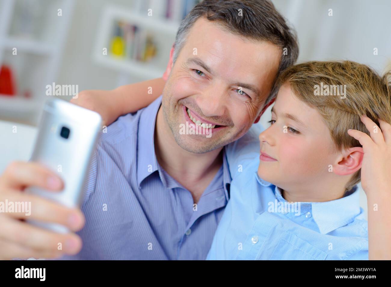 Father taking photo of himself with son Stock Photo - Alamy