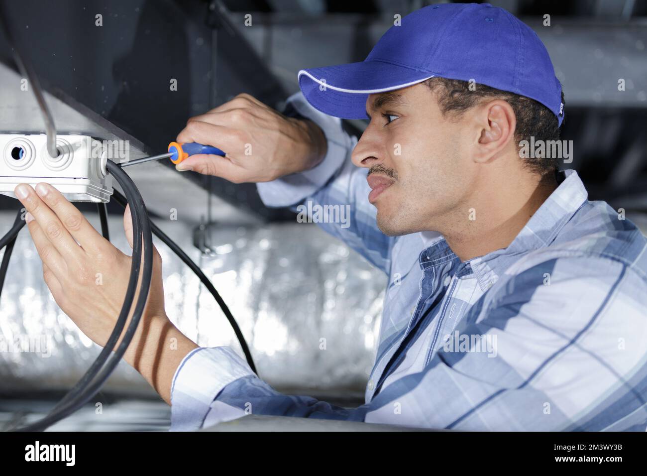 electrician installing cables in roof Stock Photo - Alamy