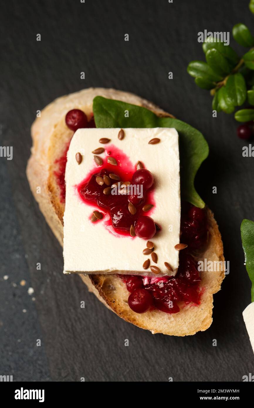 Sandwiches with goat cheese, lingonberry jam and flax seeds Stock Photo ...
