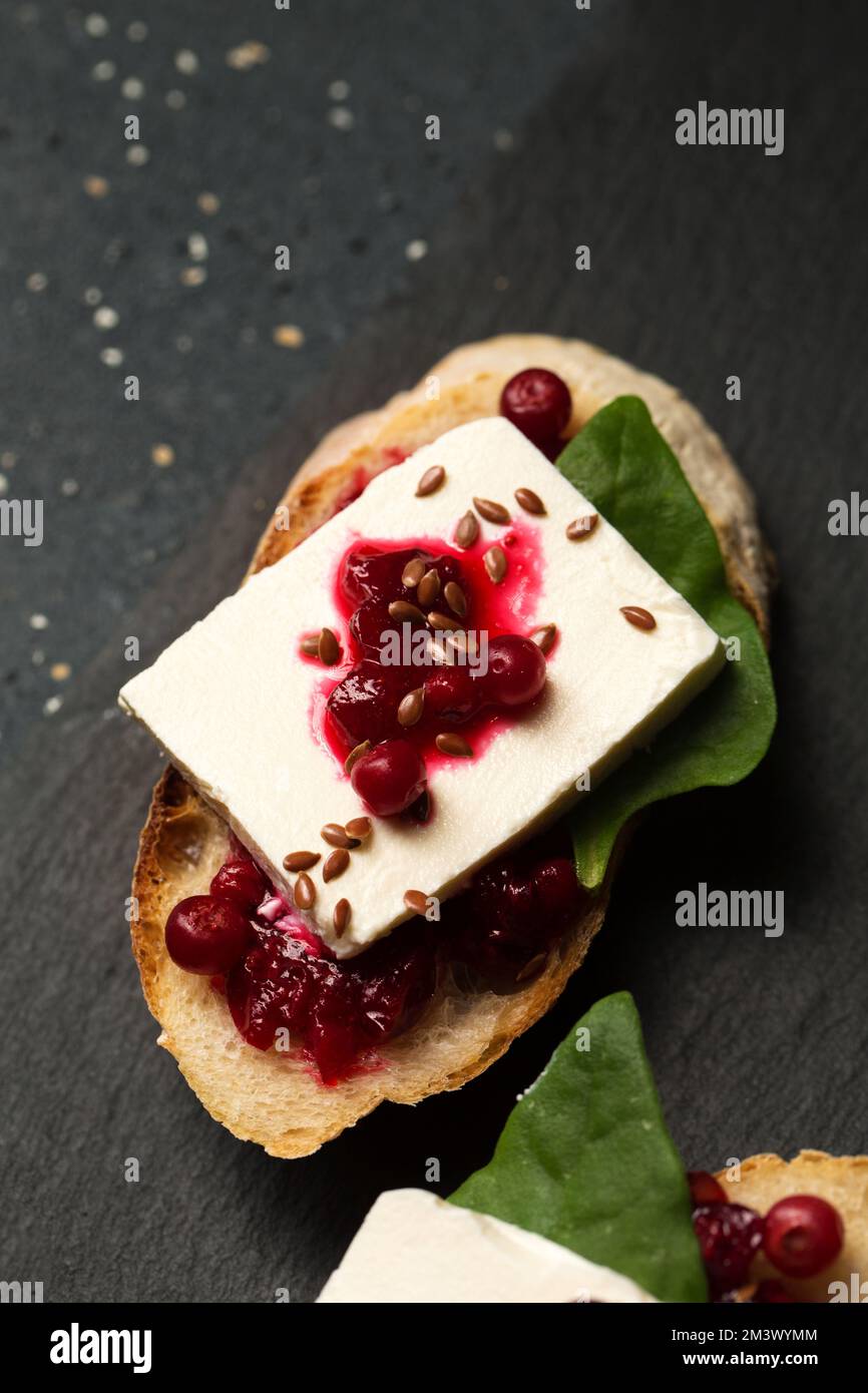 Sandwiches with goat cheese, lingonberry jam and flax seeds Stock Photo ...
