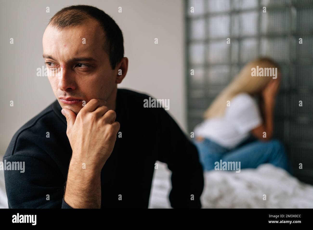 Close up face of thoughtful young man looking away not talking after ...