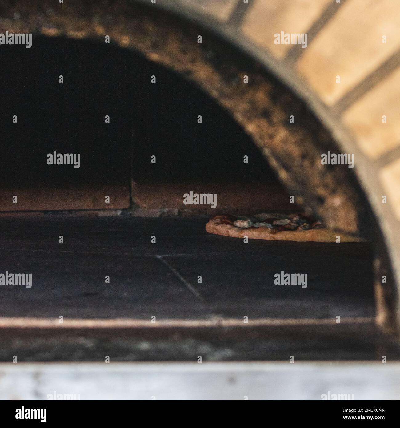 An Italian pizza baking in an oven Stock Photo - Alamy