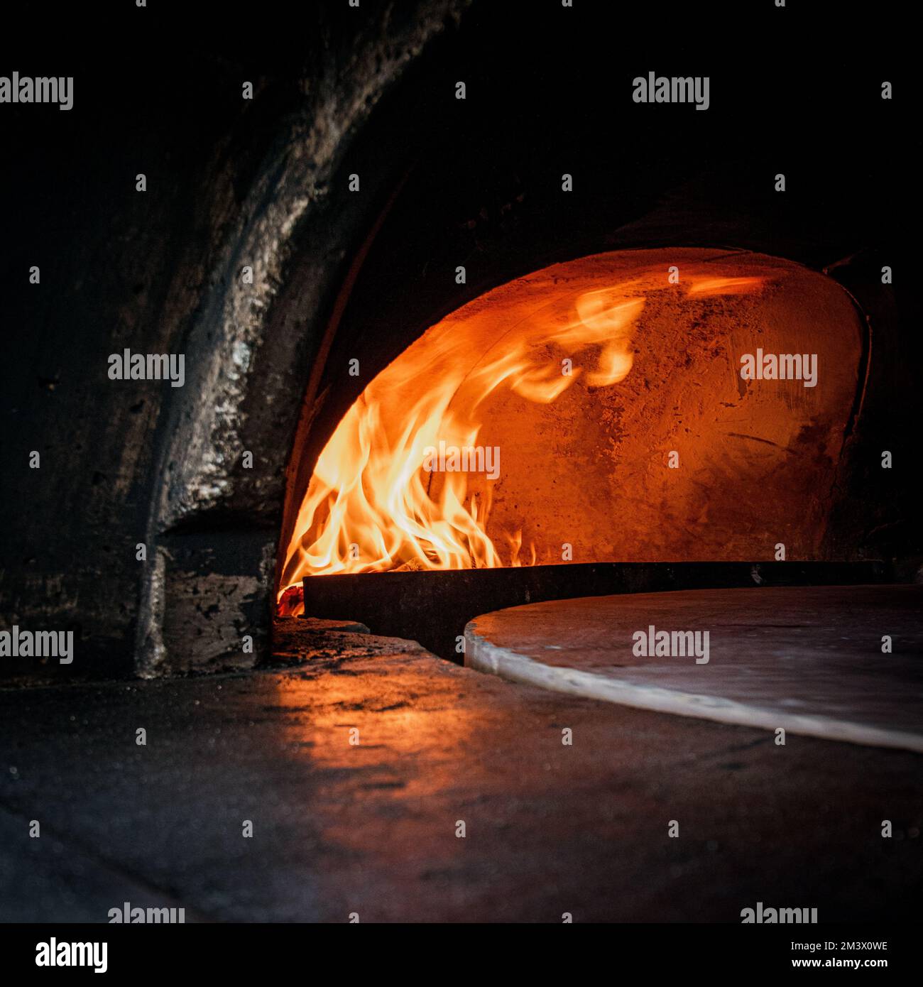A stone oven with burning fire Stock Photo - Alamy