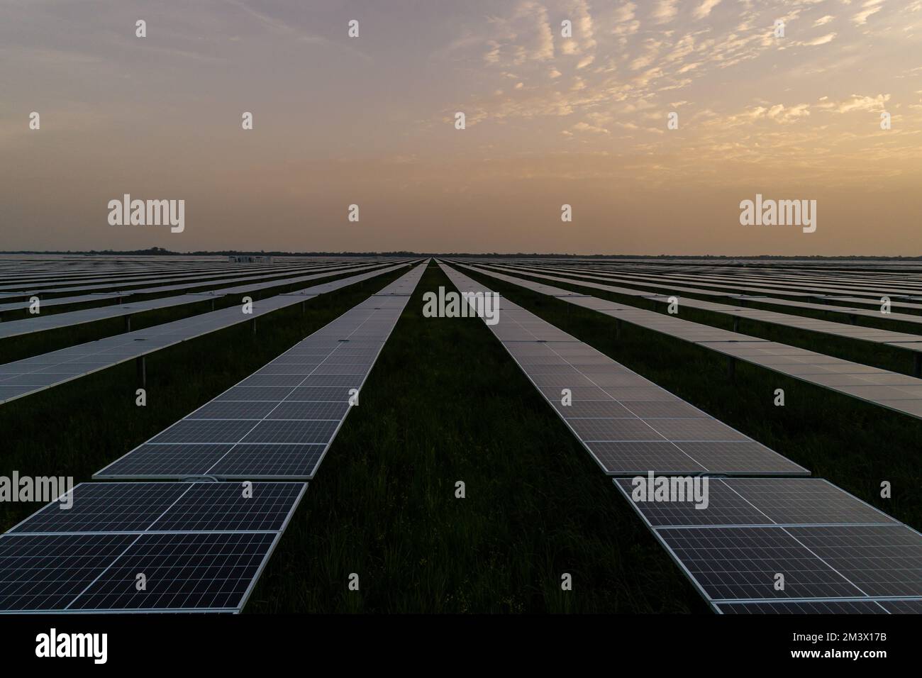 The solar power plant with lots of energy modules and panels lined up ...