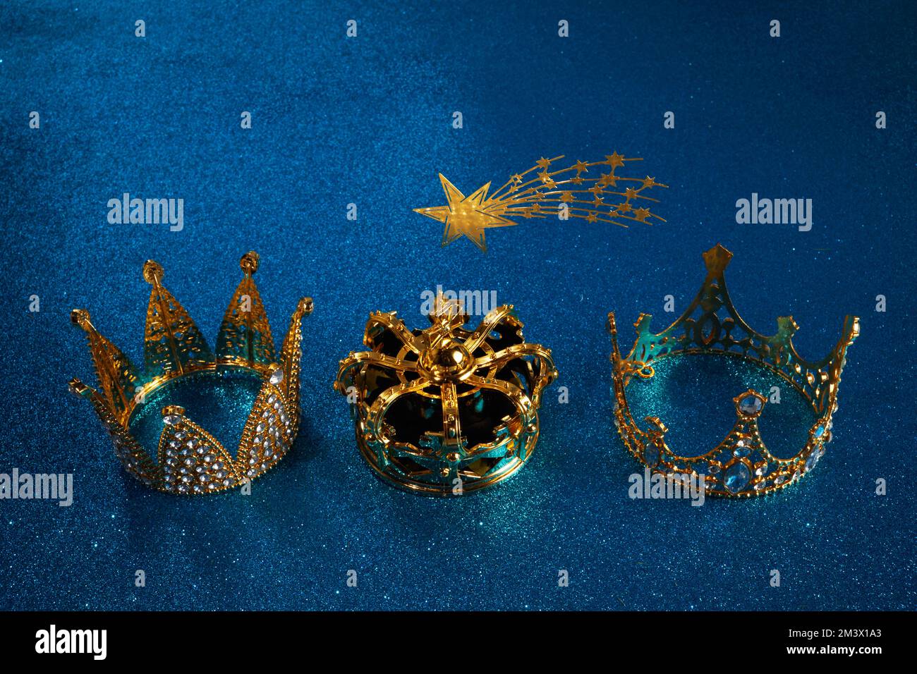 Three crowns of the three wise men with star over blue background. For ...