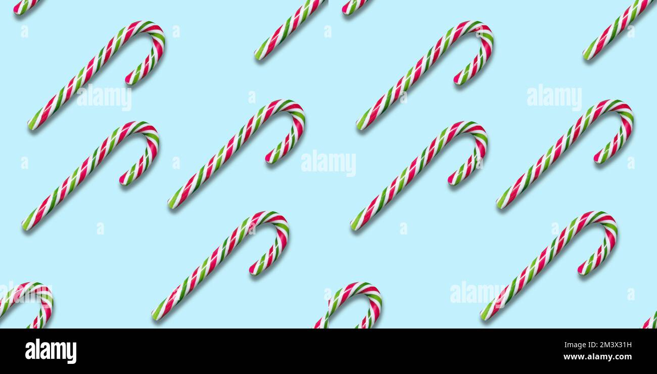 Seamless pattern of Christmas candy cane on a blue background. Flat lay ...