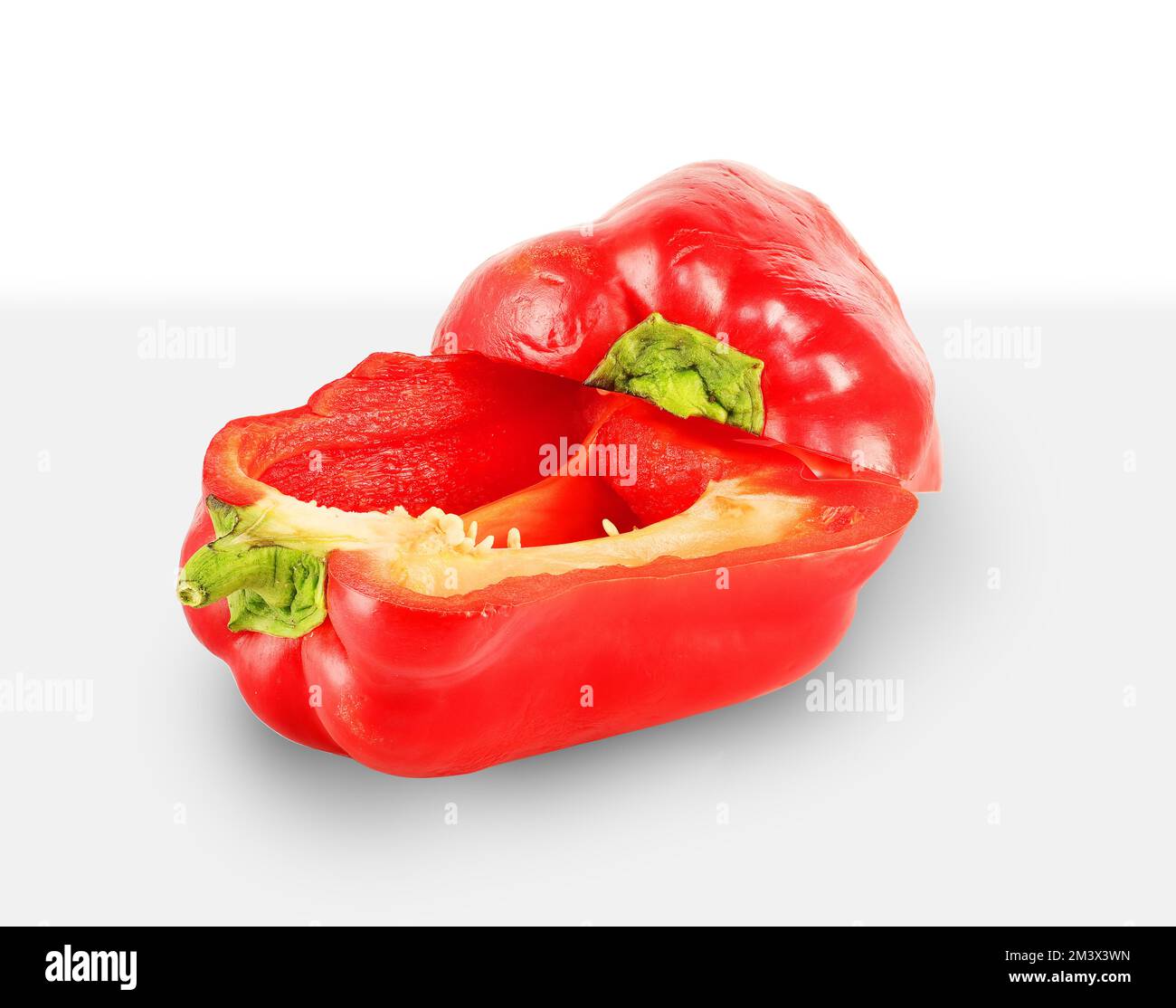 red pepper cut in half on a white background Stock Photo - Alamy