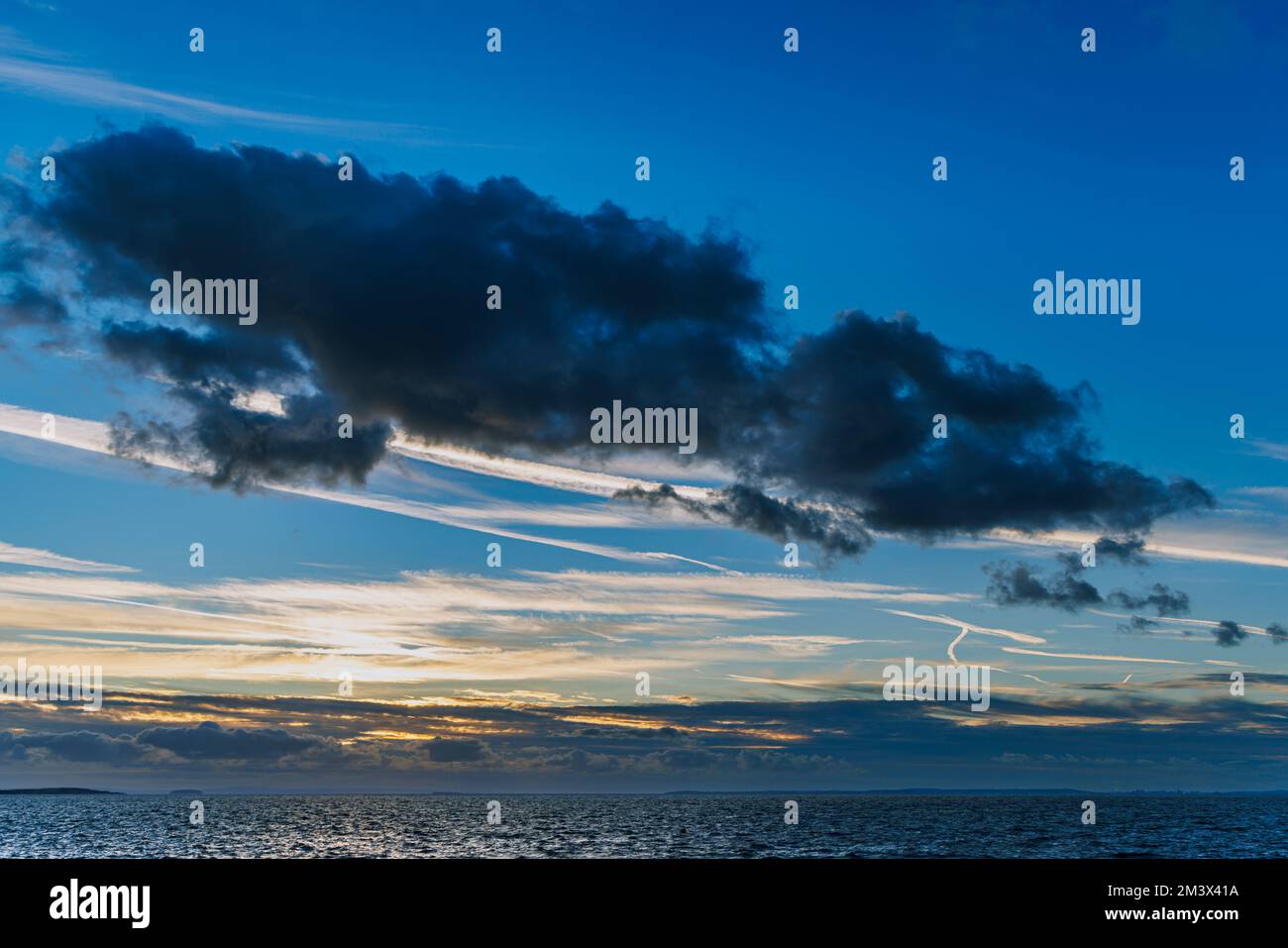 Contrails against a blue sky Stock Photo - Alamy