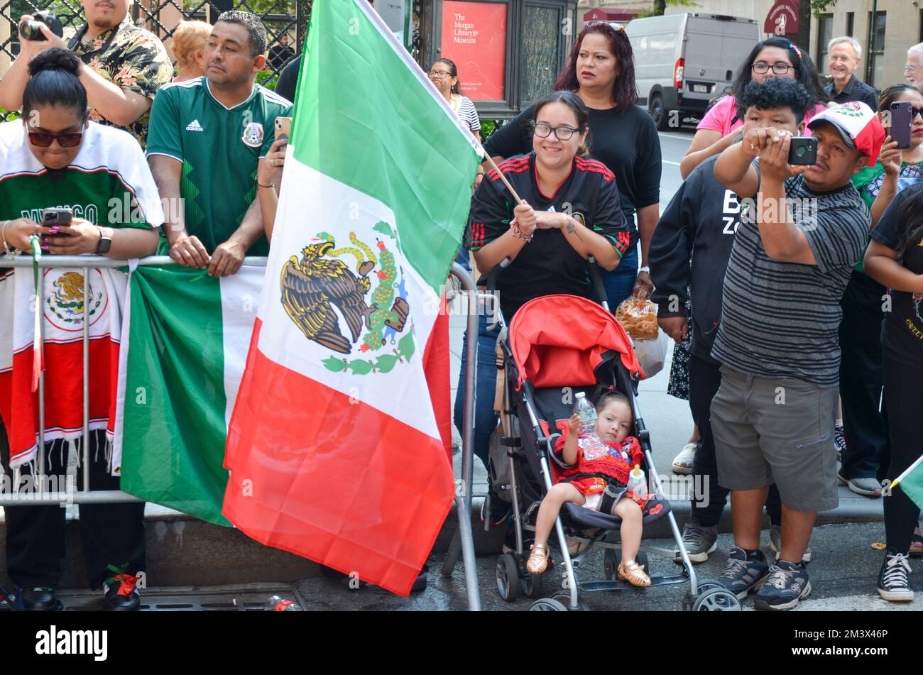 A group of people, a kid and a happy female holding a flag during the ...