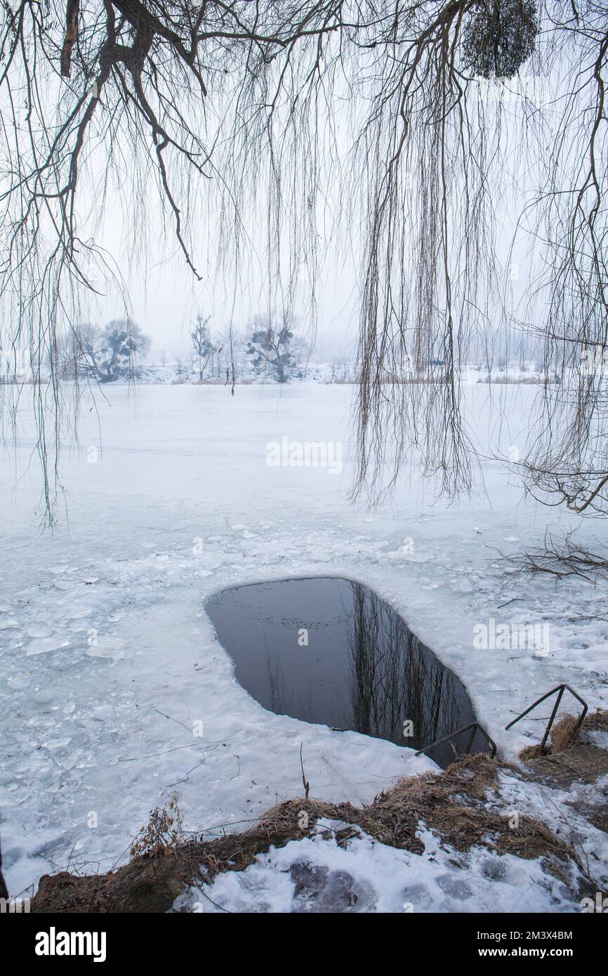 Hole cut in frozen lake hi-res stock photography and images - Alamy