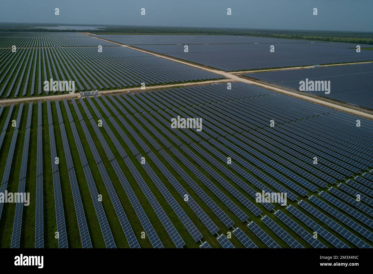 An aerial view of a vast solar energy farm with lots of solar panels ...