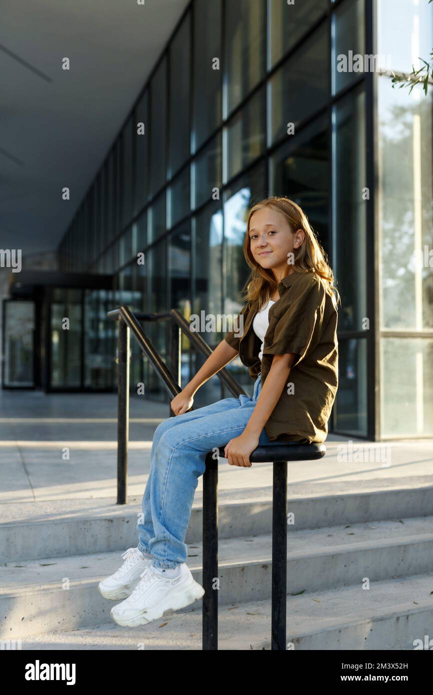 Girl sitting on stairs hi-res stock photography and images - Alamy