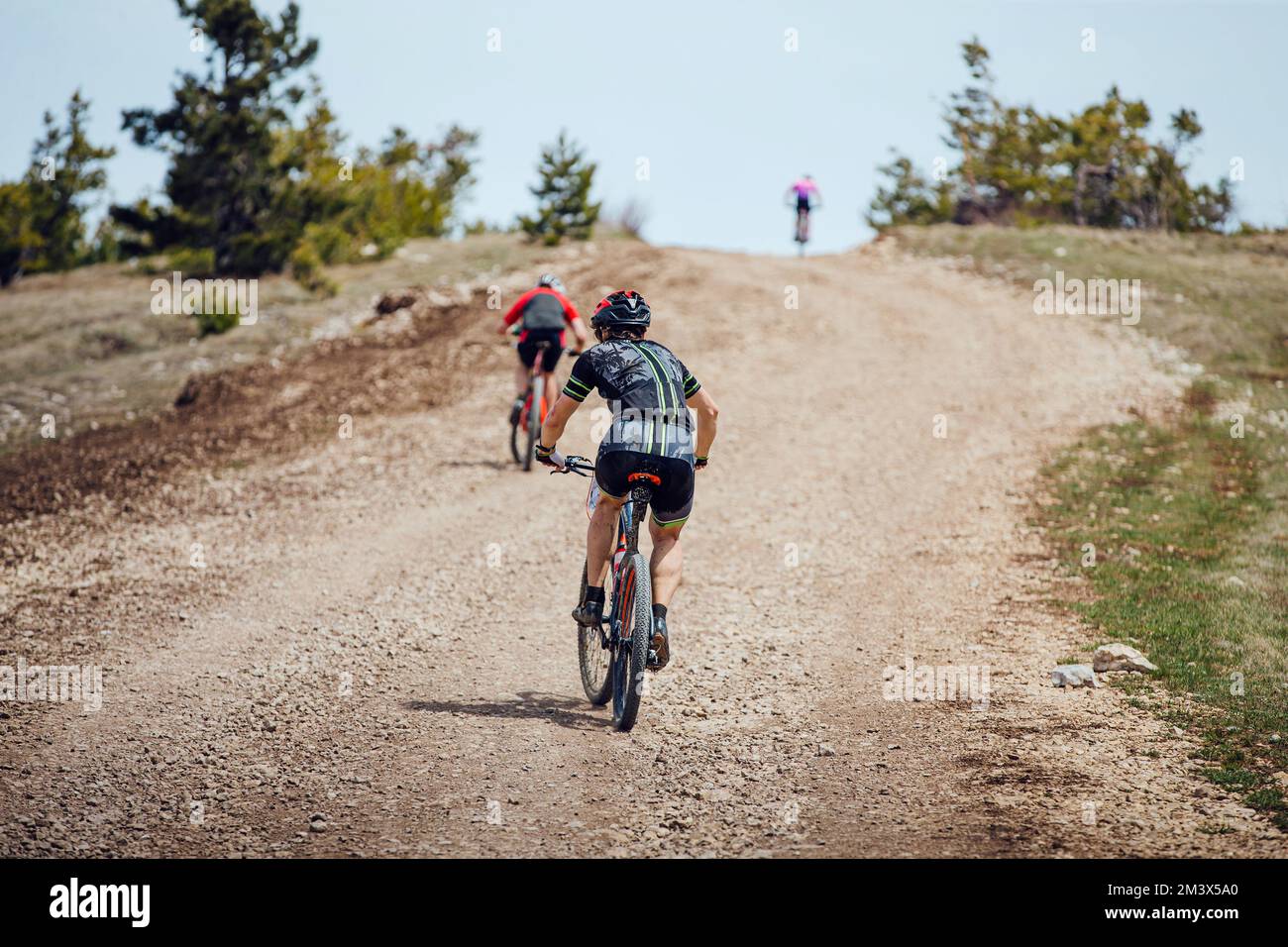 back men athletes on mountainbike riding uphill Stock Photo - Alamy