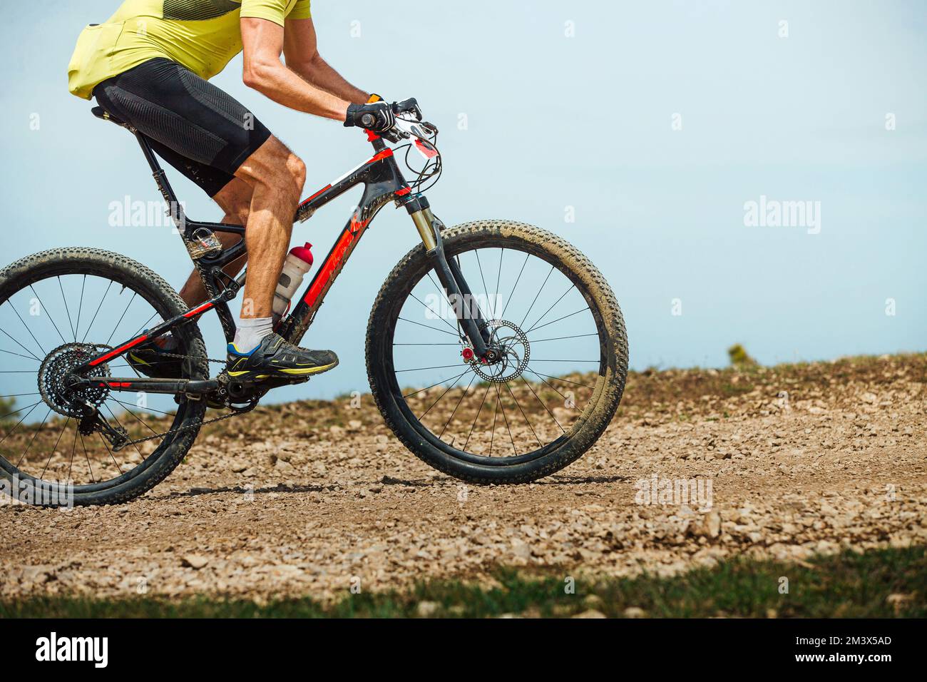 male athlete on mountainbike riding trail on background sky Stock Photo ...