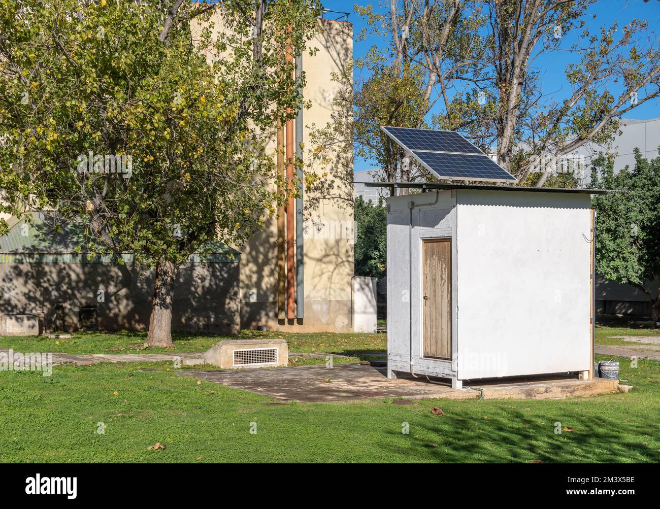 Modern rural hut with a solar panel to generate renewable energy, a ...